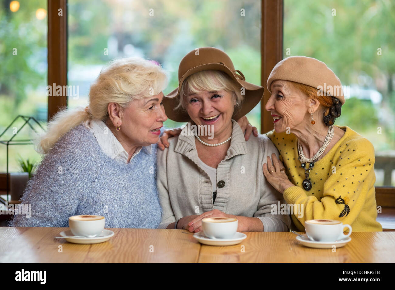 Senior women at table smiling Stock Photo - Alamy