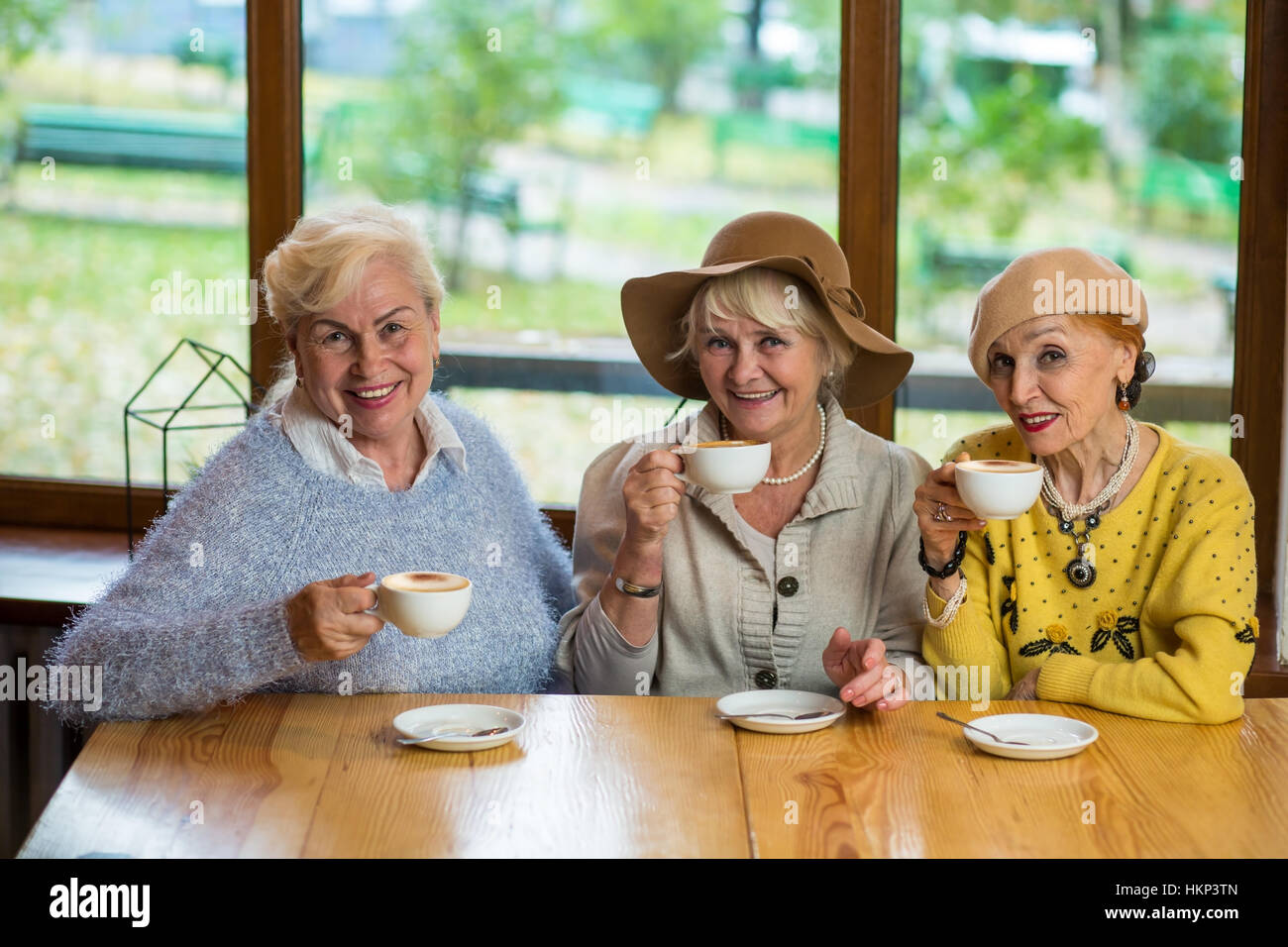 Women with coffee smiling Stock Photo - Alamy