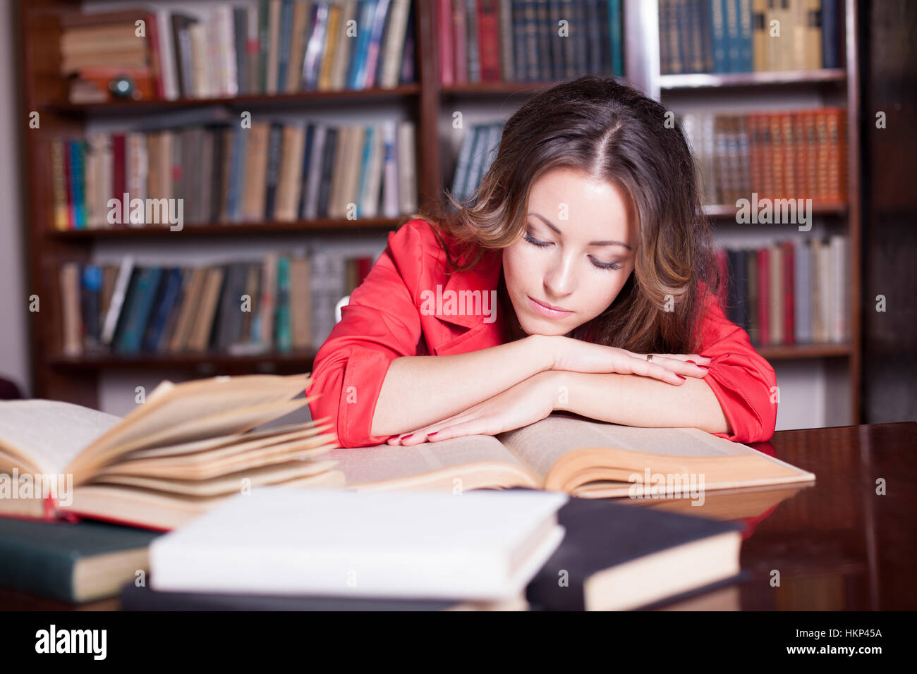 girl reading book in the library is preparing for exams Stock Photo - Alamy