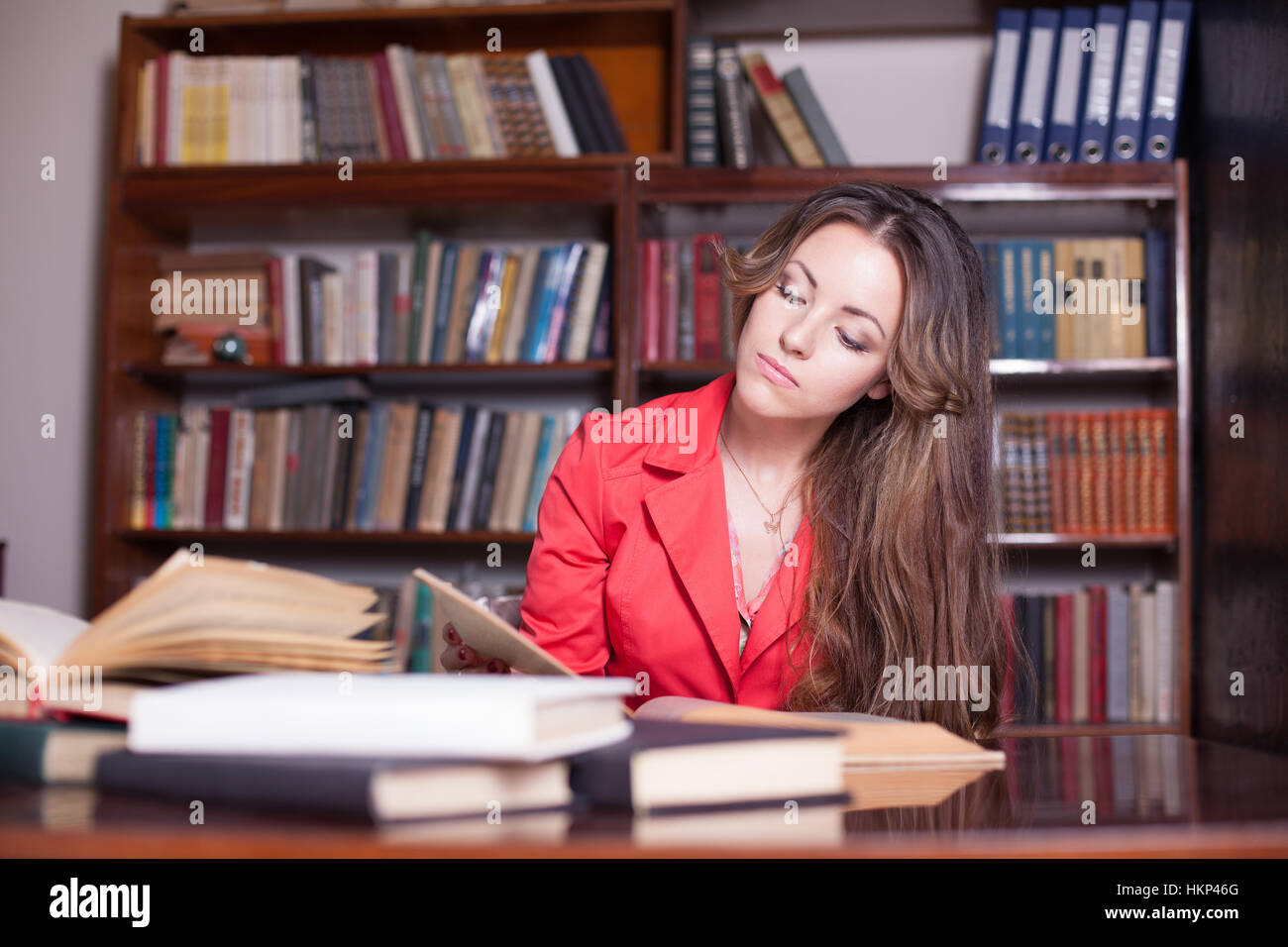 girl reading book in the library is preparing for exams Stock Photo - Alamy