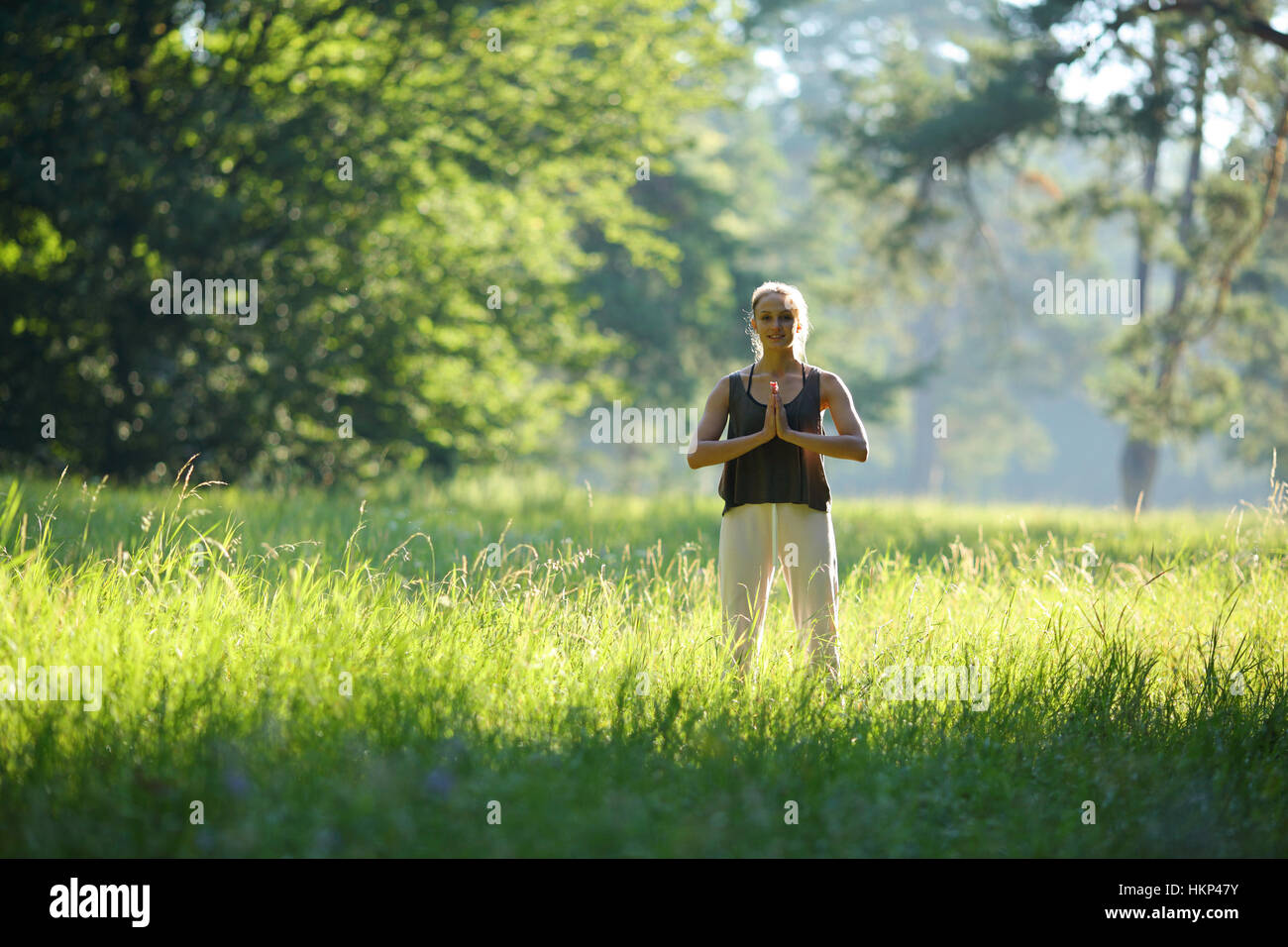 Young woman smilling and standin with praying hands Stock Photo - Alamy Young woman smilling and standin with praying hands Stock Photo - Alamy