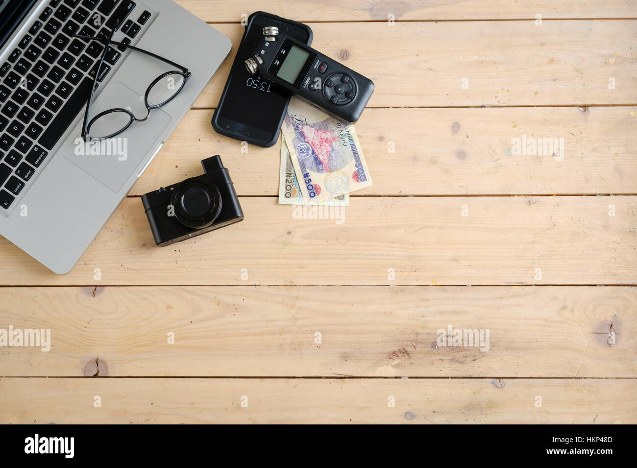 Wooden desk with various gadgets and accessories Stock Photo - Alamy