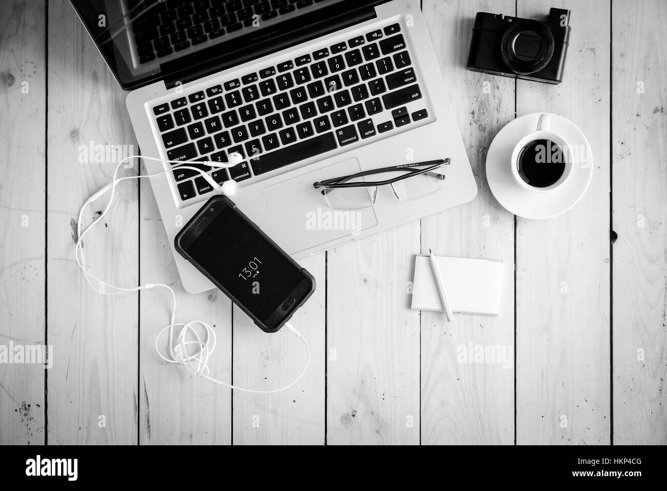 Wooden desk with various gadgets and accessories Stock Photo - Alamy