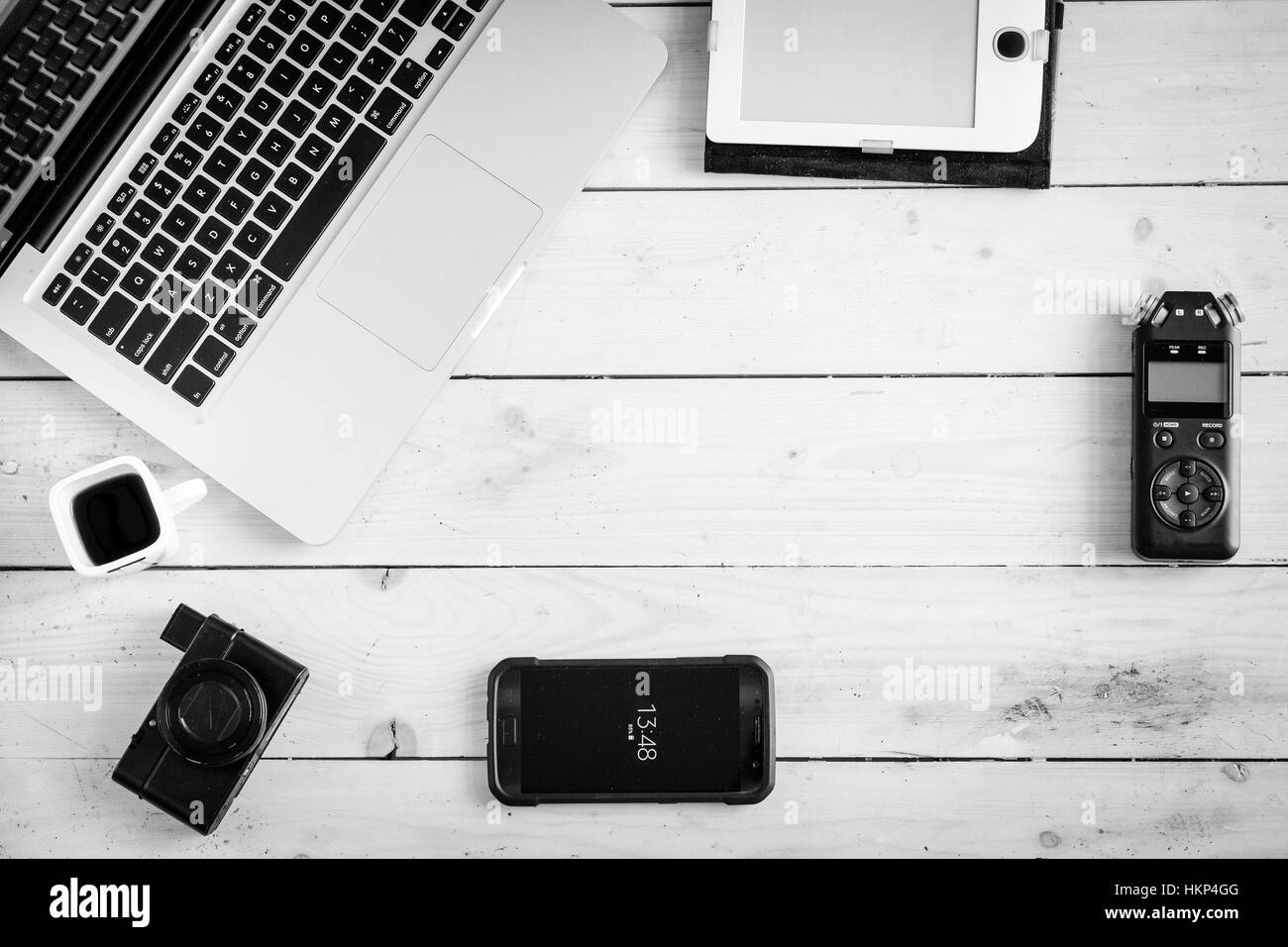 Wooden desk with various gadgets and accessories Stock Photo - Alamy