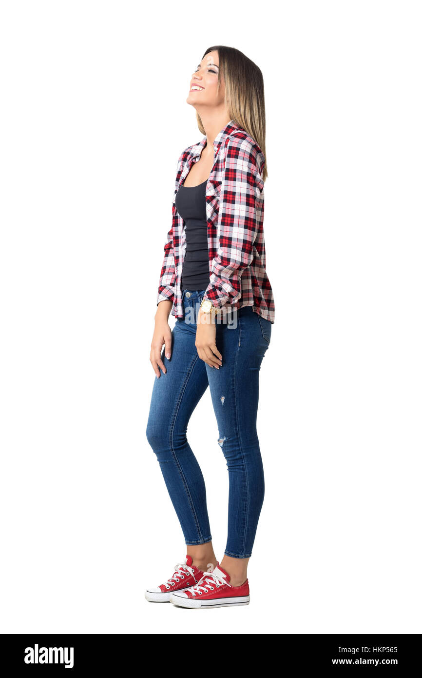 Side view of young casual girl laughing with closed eyes and head ...