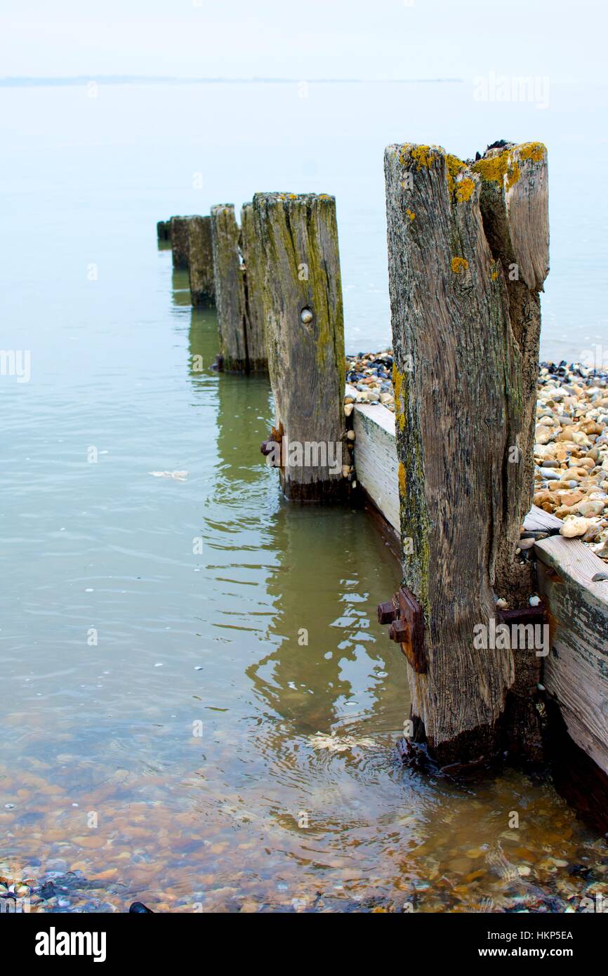 Rusty bolt and wooden post by the sea Stock Photo - Alamy