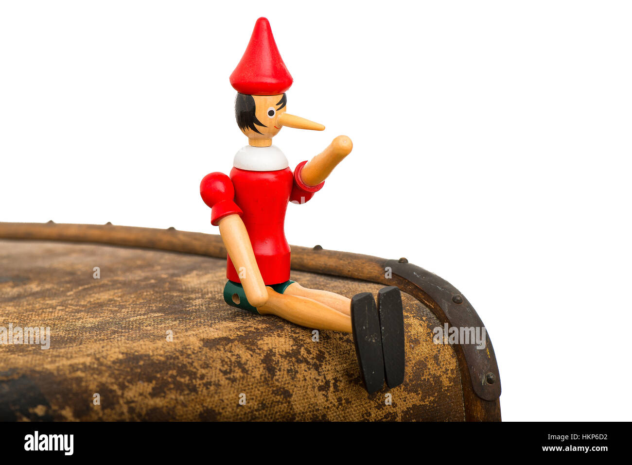 Pinocchio the puppet sitting on a trunk with white background Stock ...