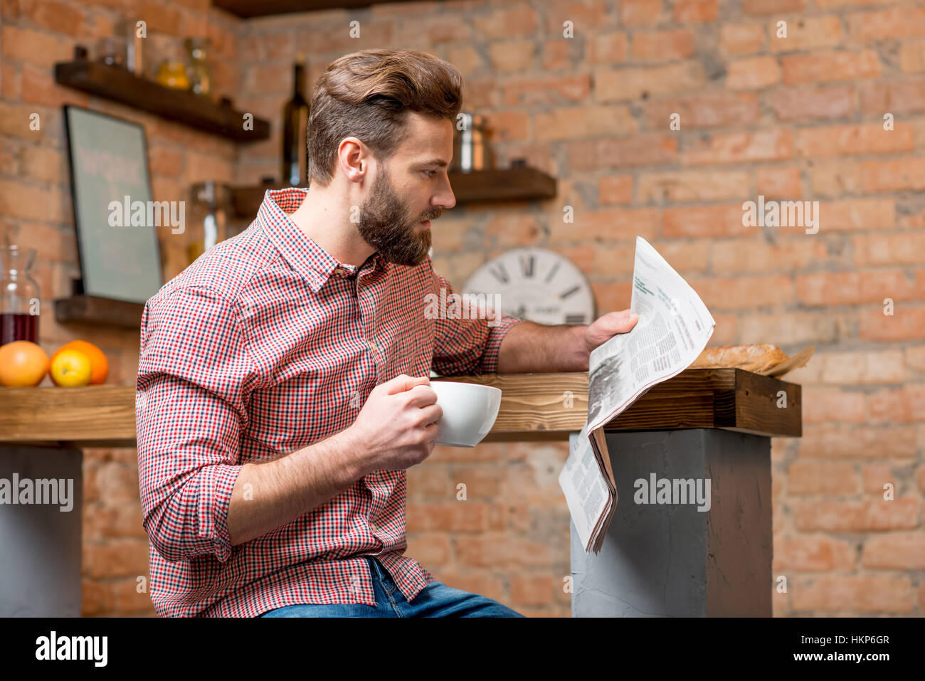 Man having breakfast at the kitchen Stock Photo - Alamy