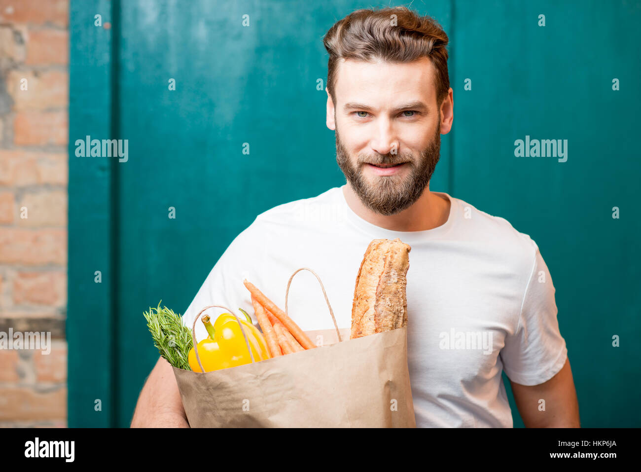Man with bag full of food Stock Photo - Alamy