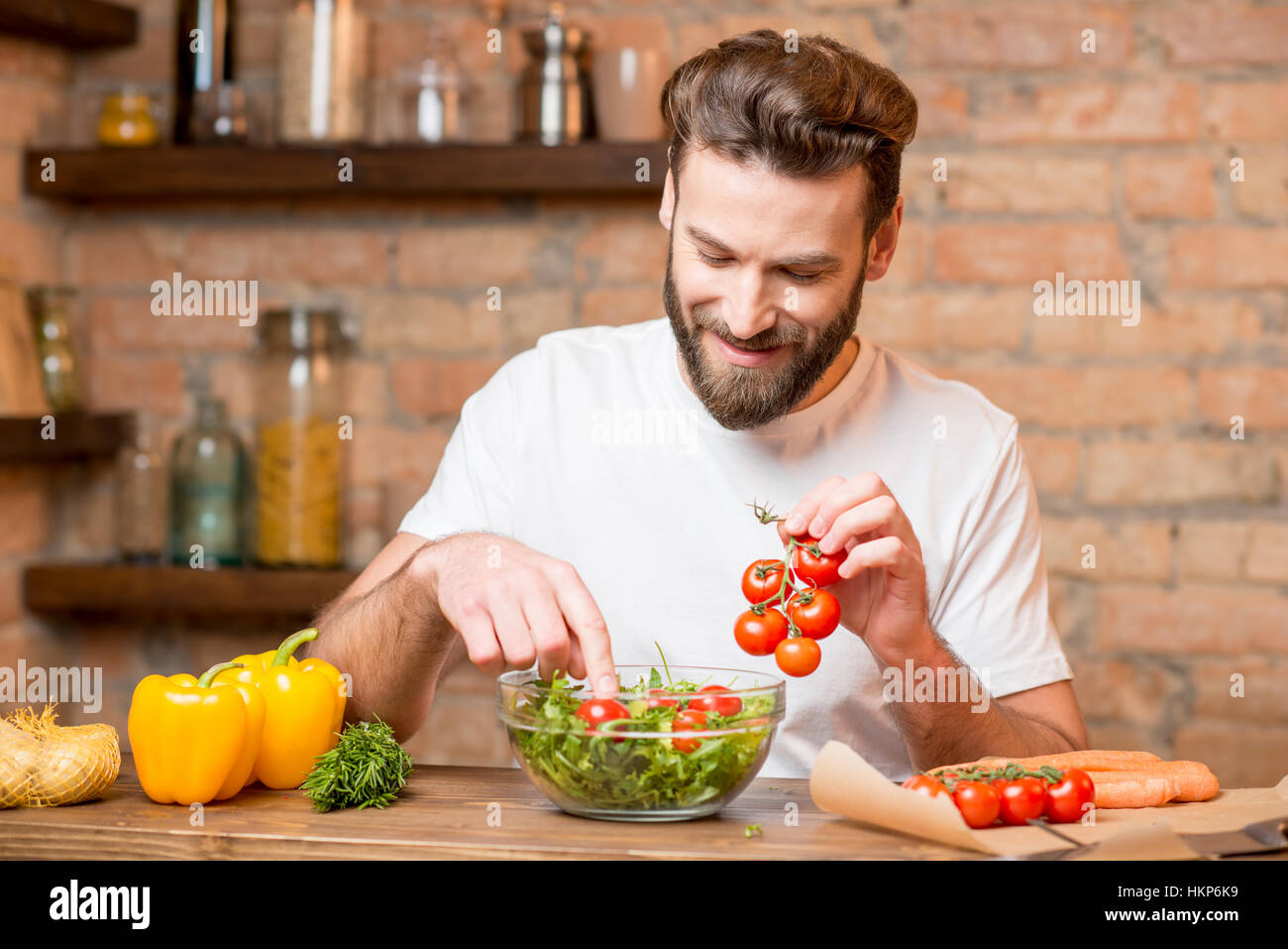 Man making salad Stock Photo - Alamy