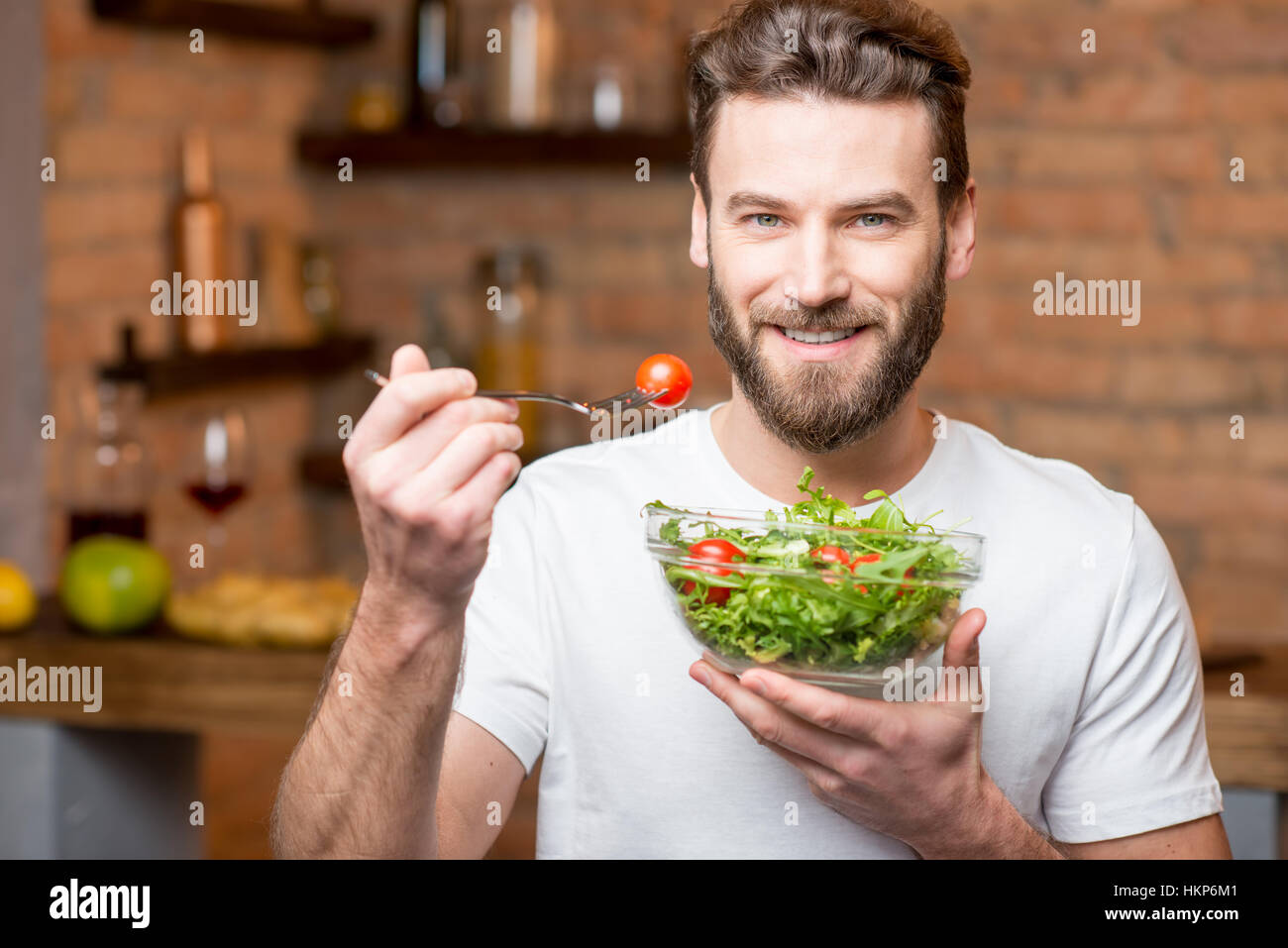 Man eating salad Stock Photo - Alamy