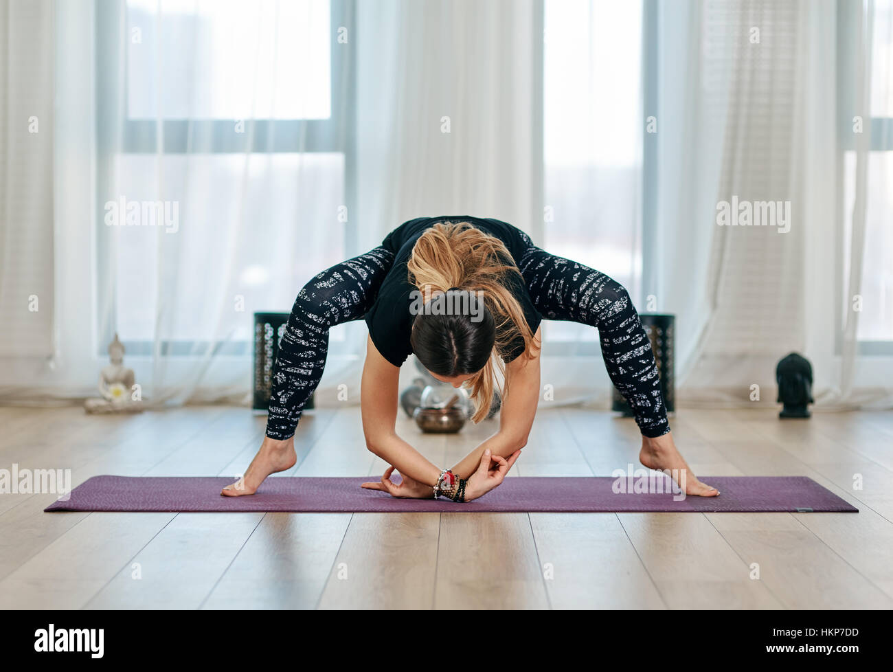 Yoga teacher in various postures (asana) in a studio Stock Photo - Alamy