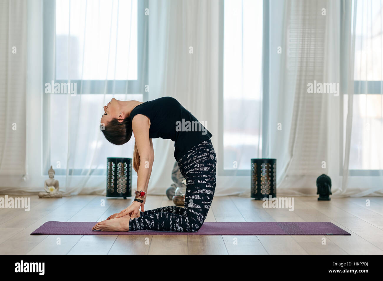 Yoga teacher in various postures (asana) in a studio Stock Photo - Alamy