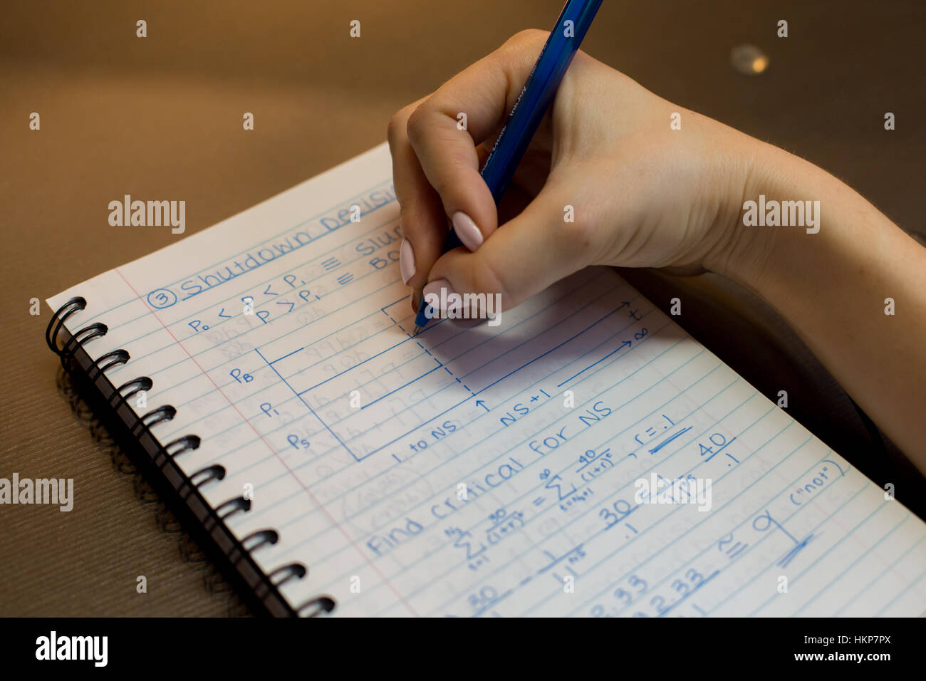 Student taking drawing a graph in economics class Stock Photo - Alamy