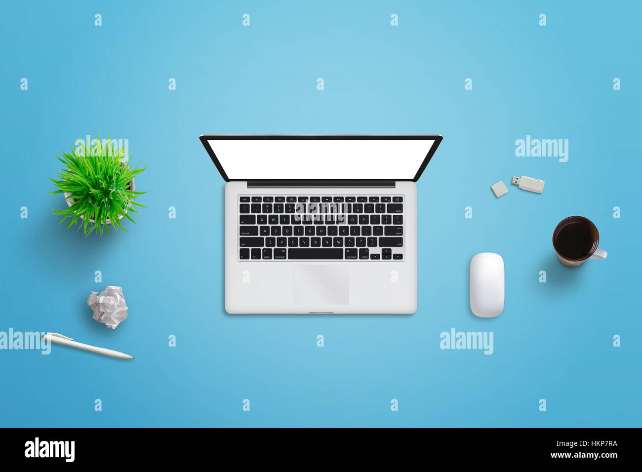 Blue office desk with laptop computer, coffee, plant, mouse, paper ...