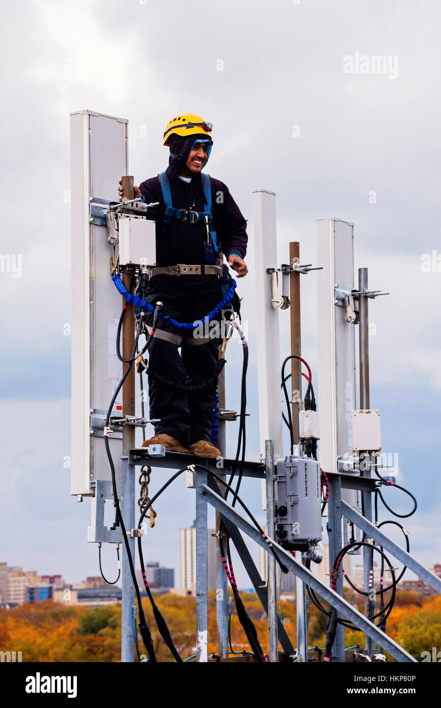 Tower crew leader working on the heights with the cellular antennas ...