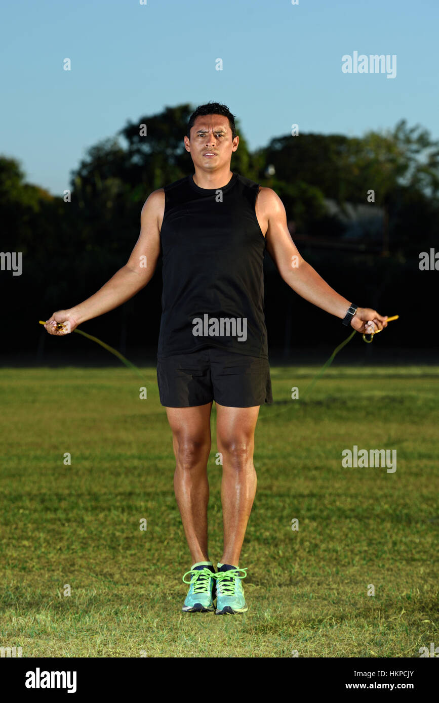 sportman man jumping rope on green lawn park Stock Photo - Alamy
