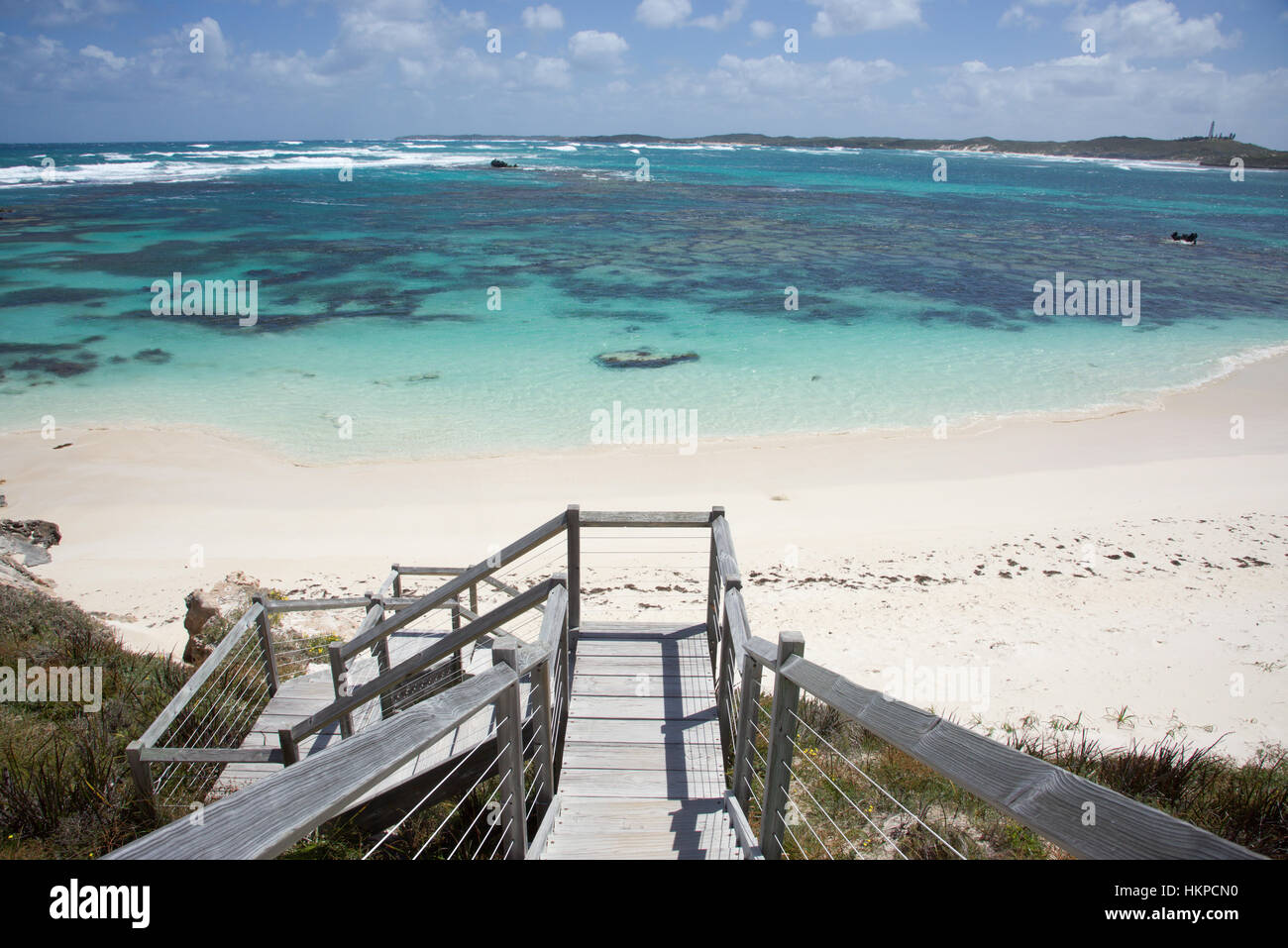 Scenic view from walkway to remote sandy beach with coral reef at ...