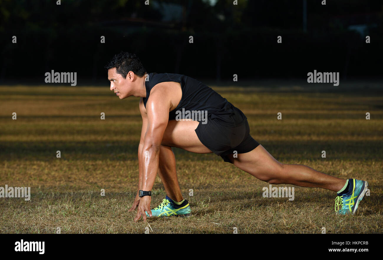 sport man ready to start run on grass park Stock Photo - Alamy