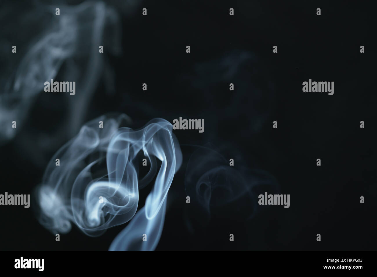 mystery dense blue smoke over dark background Stock Photo - Alamy