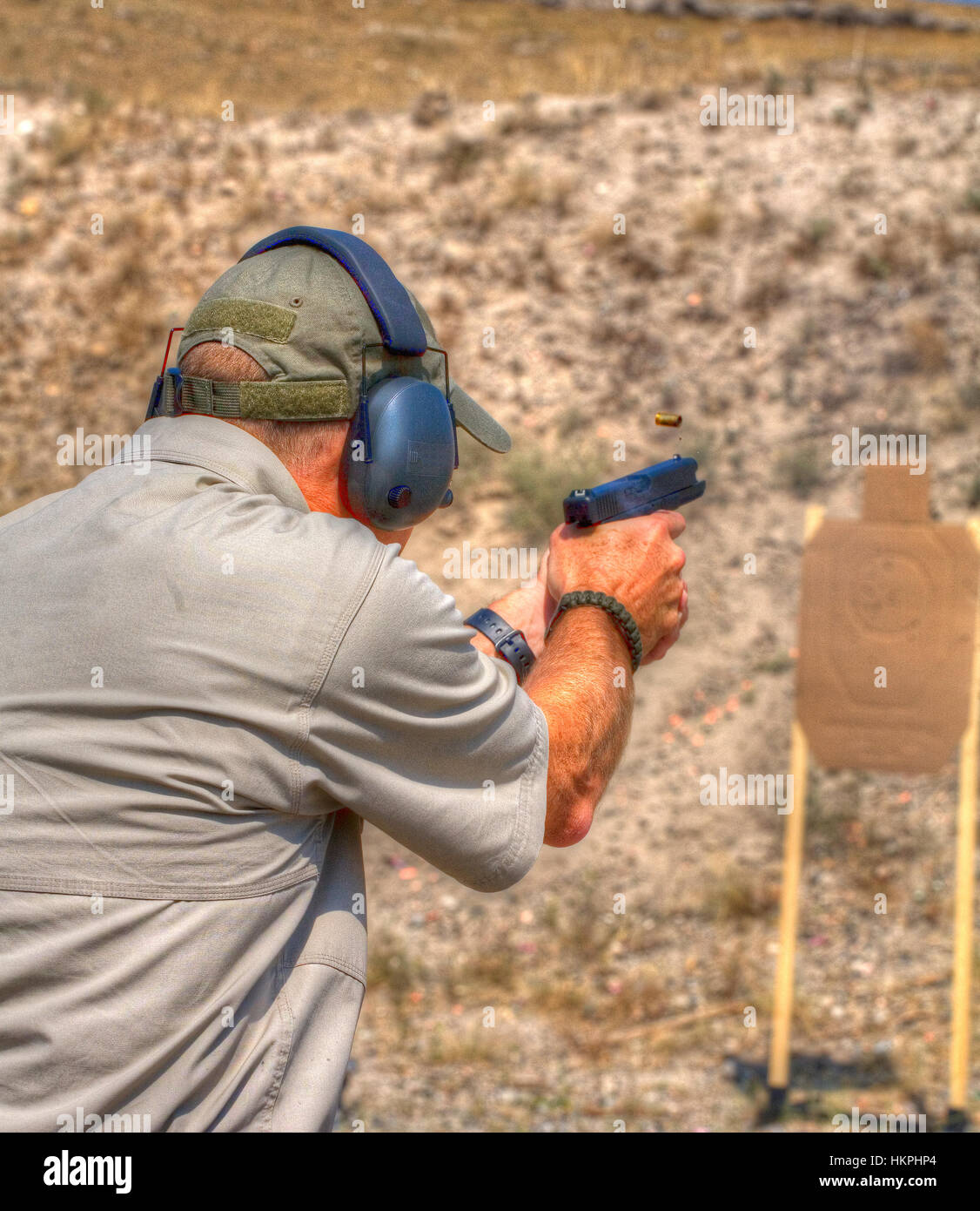 Marksman practicing at the range with a polymer handgun Stock Photo - Alamy