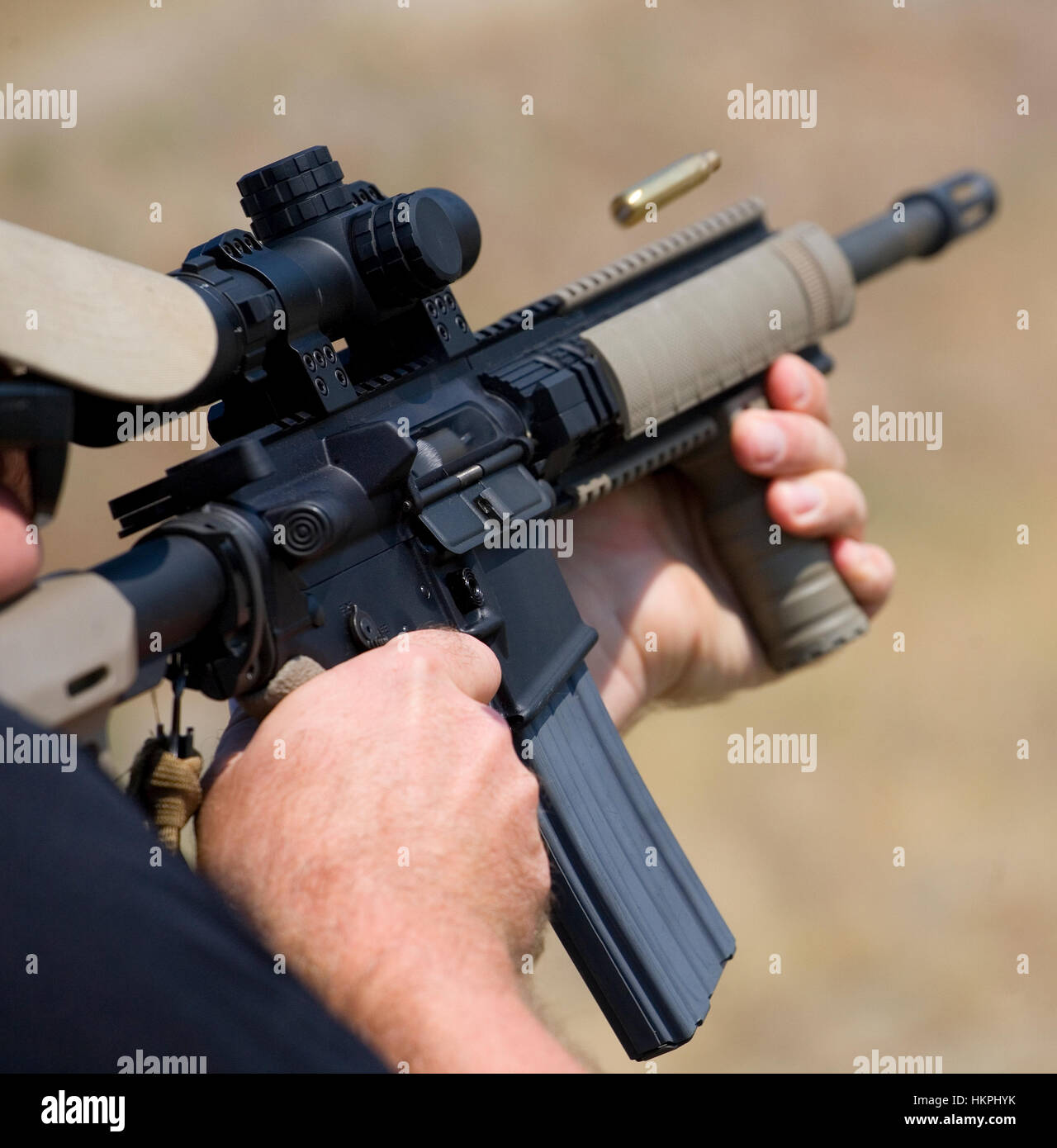 Brass hangs in the air as a shooter takes a single shot Stock Photo - Alamy