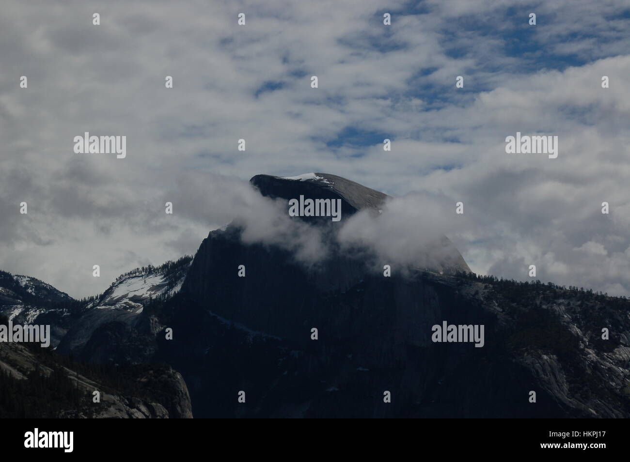 Half Dome covered in a layer of clouds in Yosemite Valley, CA. Picture ...