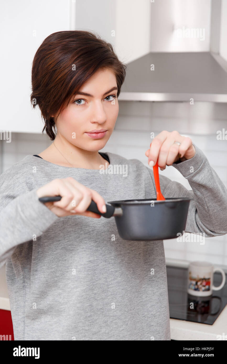 Girl with saucepan in hand Stock Photo - Alamy