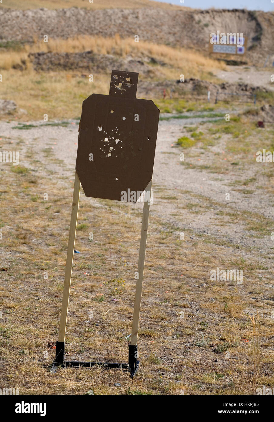 Cardboard silhouette target with holes in it at the range Stock Photo ...