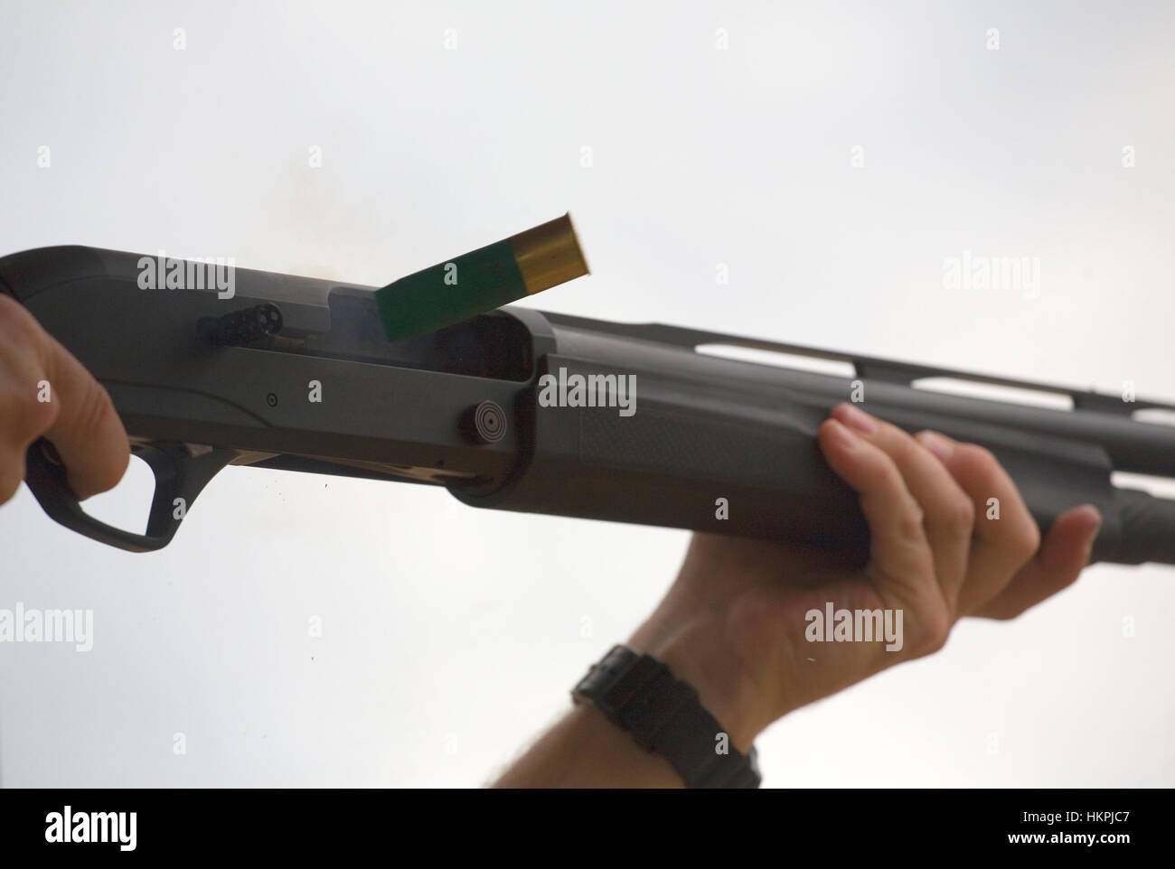 Smoking and moving semi auto shotgun as an empty shell is ejected Stock ...