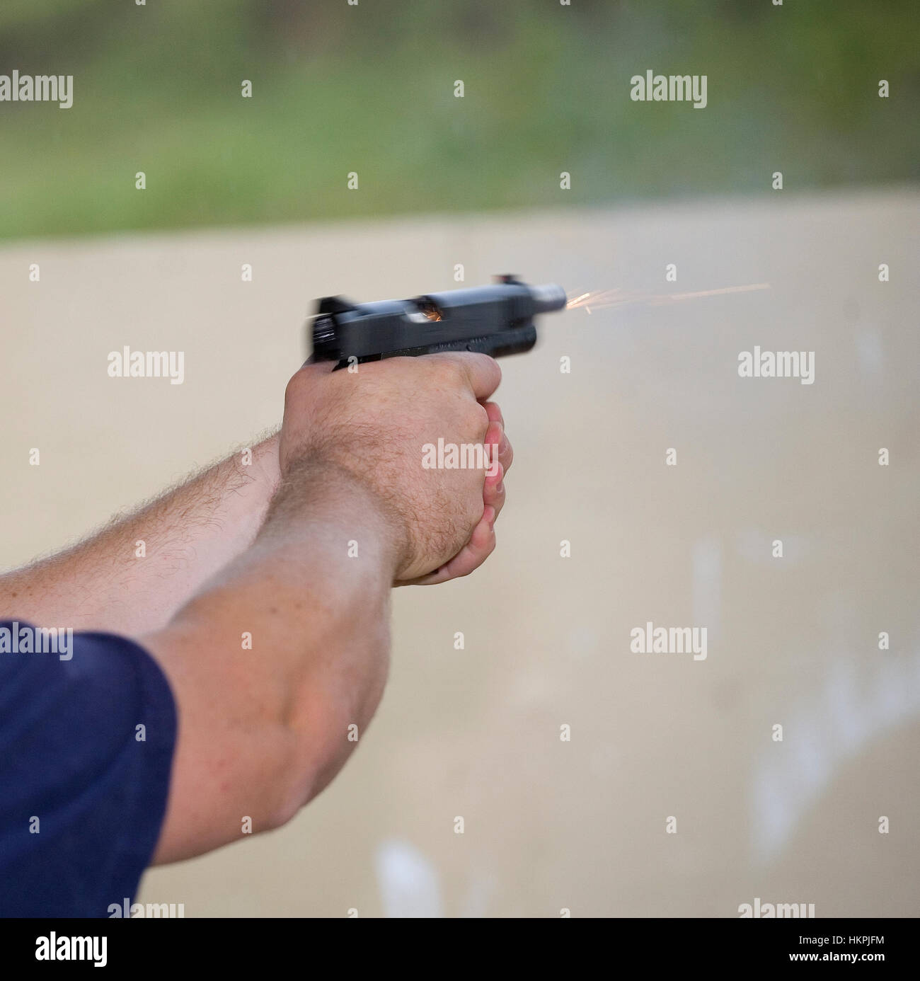 Handgun with the slide moving and sparks coming out Stock Photo - Alamy