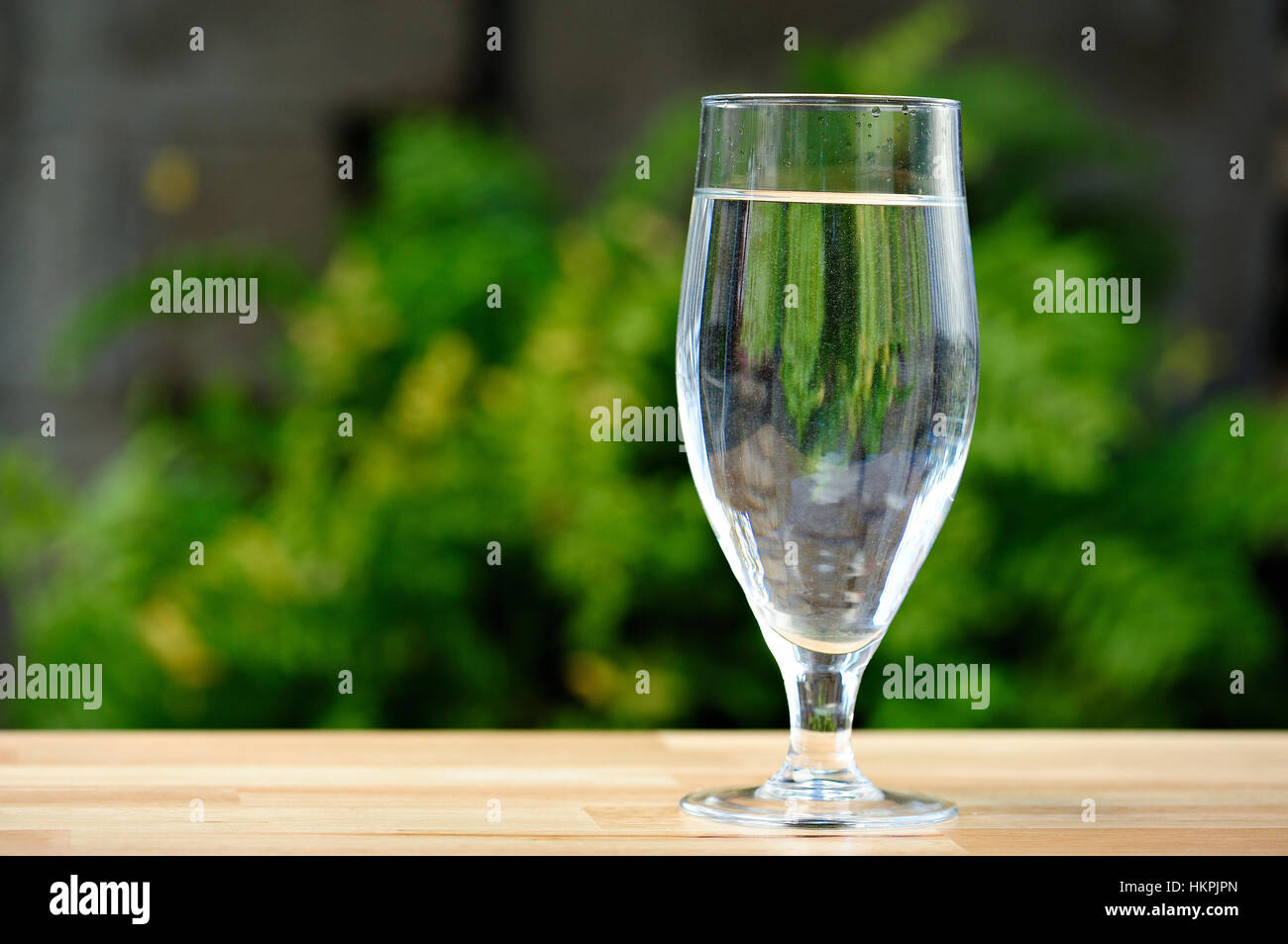 big glass with water on table green park Stock Photo - Alamy