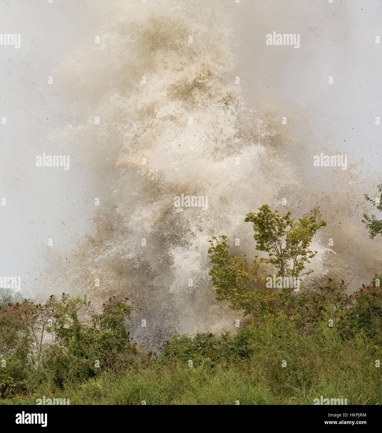 Explosion that has sent water from a stream well above full grown trees ...
