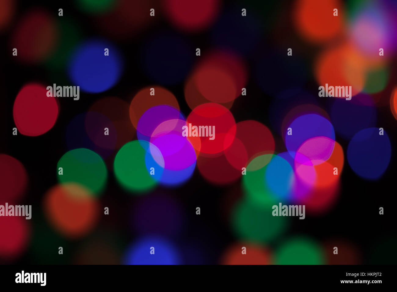 Abstract background with large coloured bokeh lights on black Stock ...