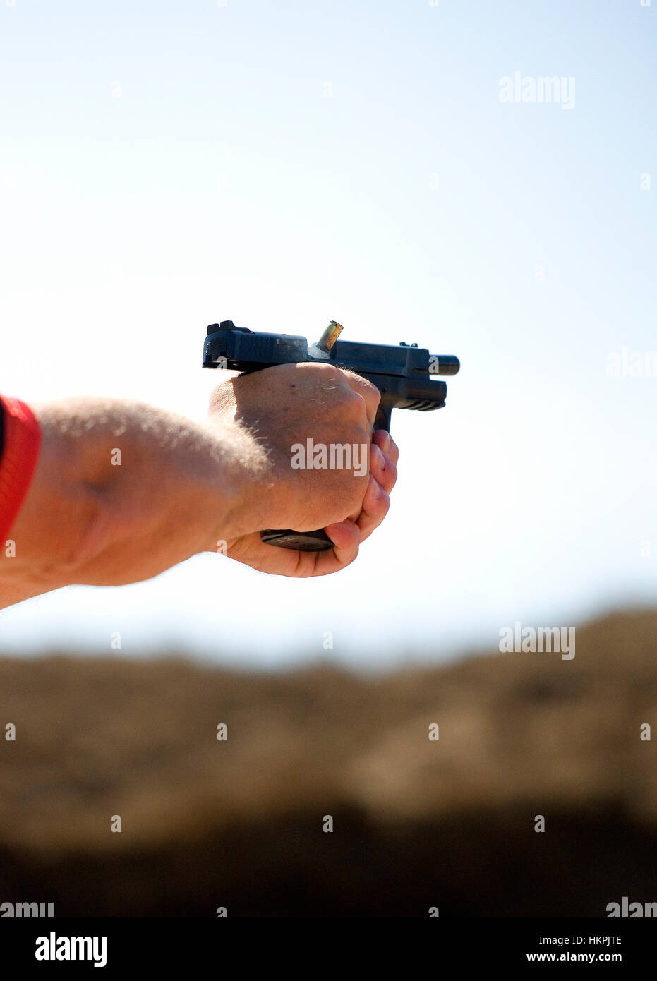 Empty shell being enjected from a semi automatic handgun Stock Photo ...