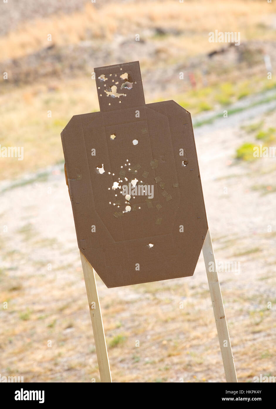 Silhouette target at the range with a lot of holes in it Stock Photo ...