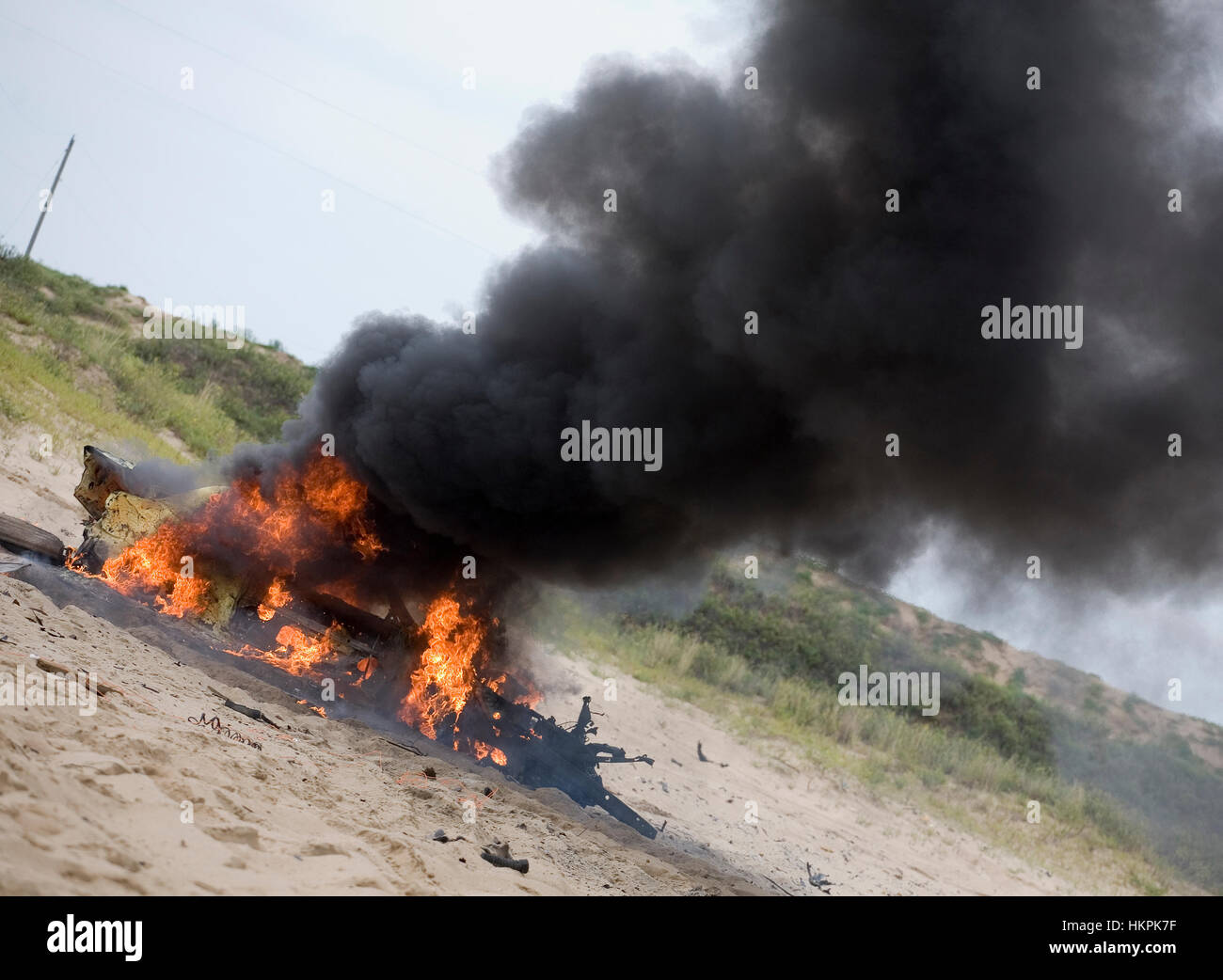 Remnants of a car burning and smoking after an explosion Stock Photo ...