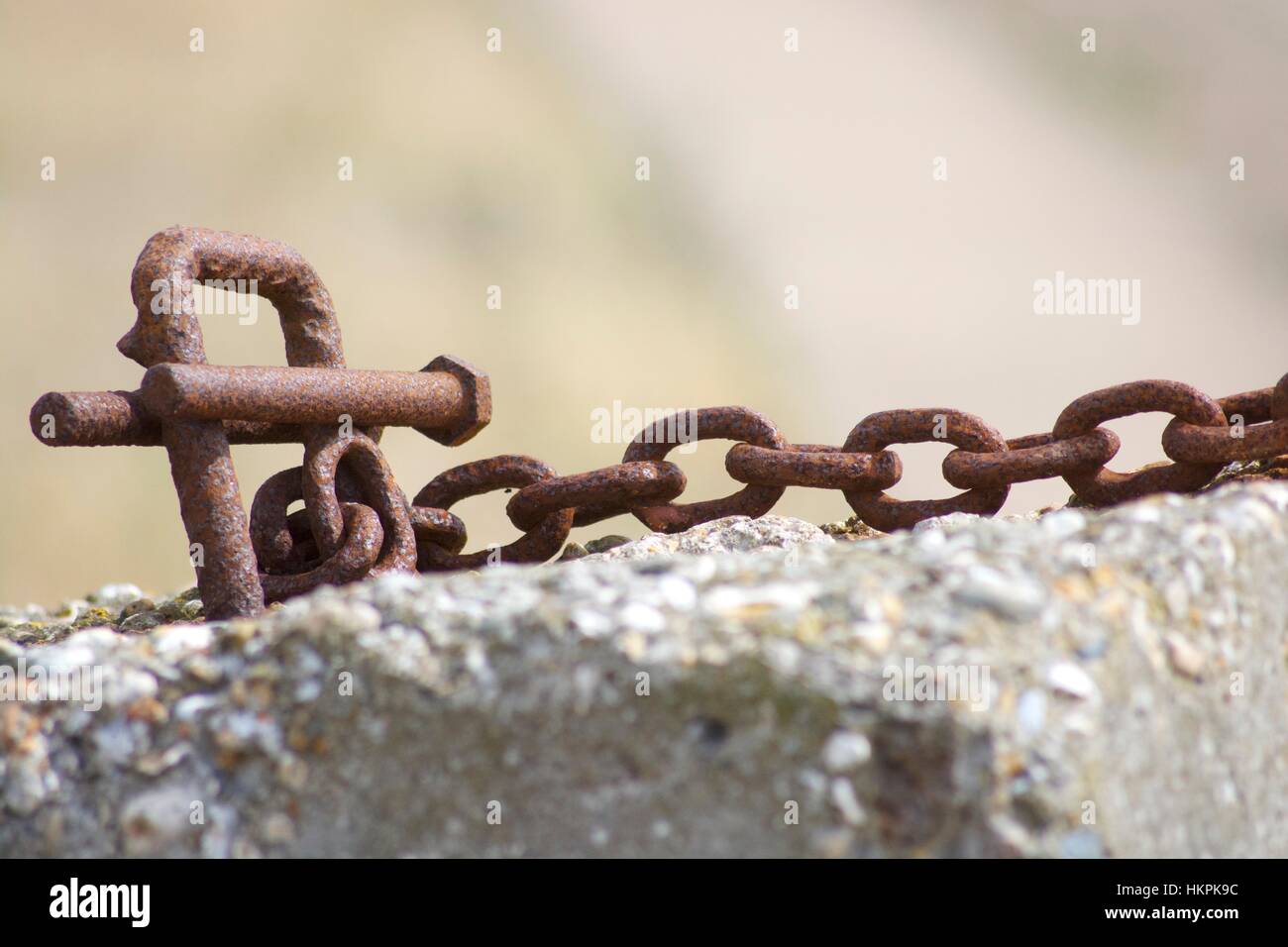 Rusty Chain and stone on Dungeness beach in Kent Stock Photo - Alamy
