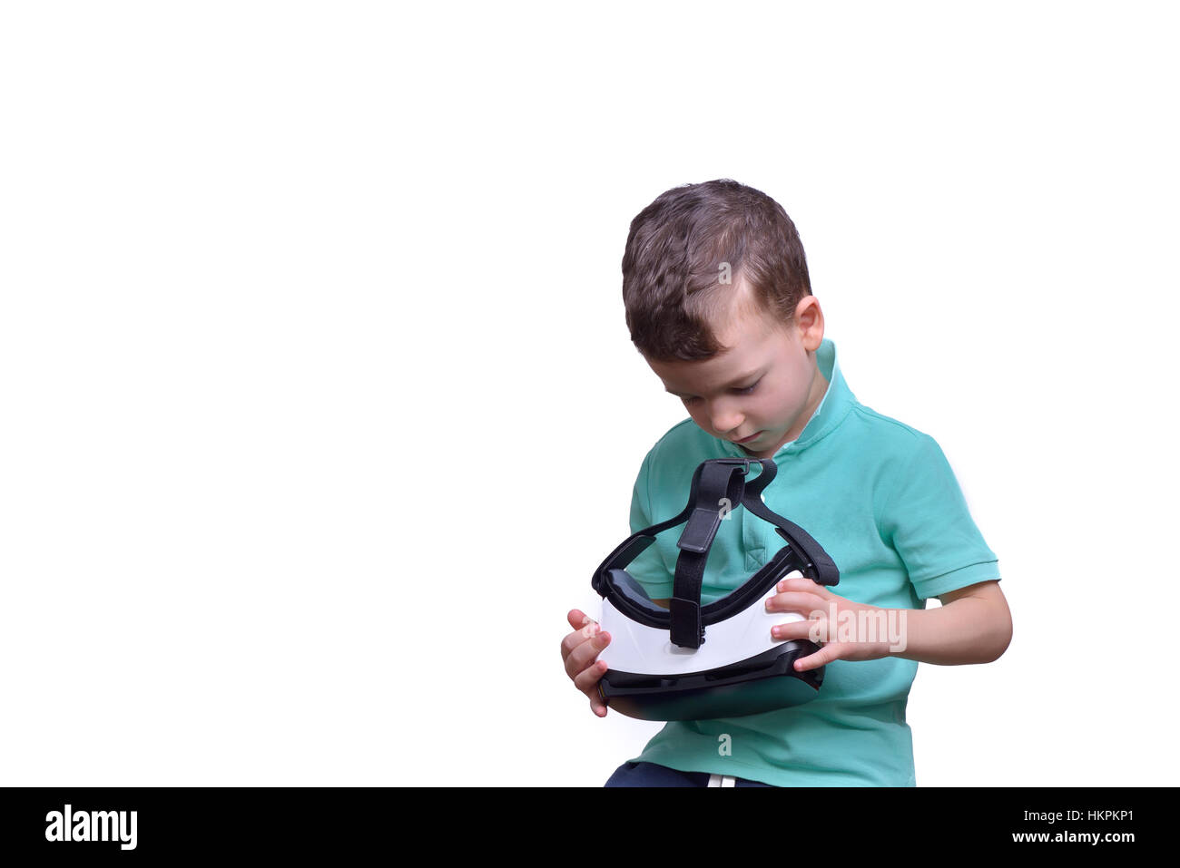 Amazed teen boy wearing virtual reality goggles watching movies or ...