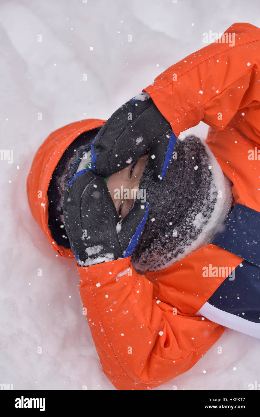 Funny little kid boy in colorful clothes playing outdoors during ...