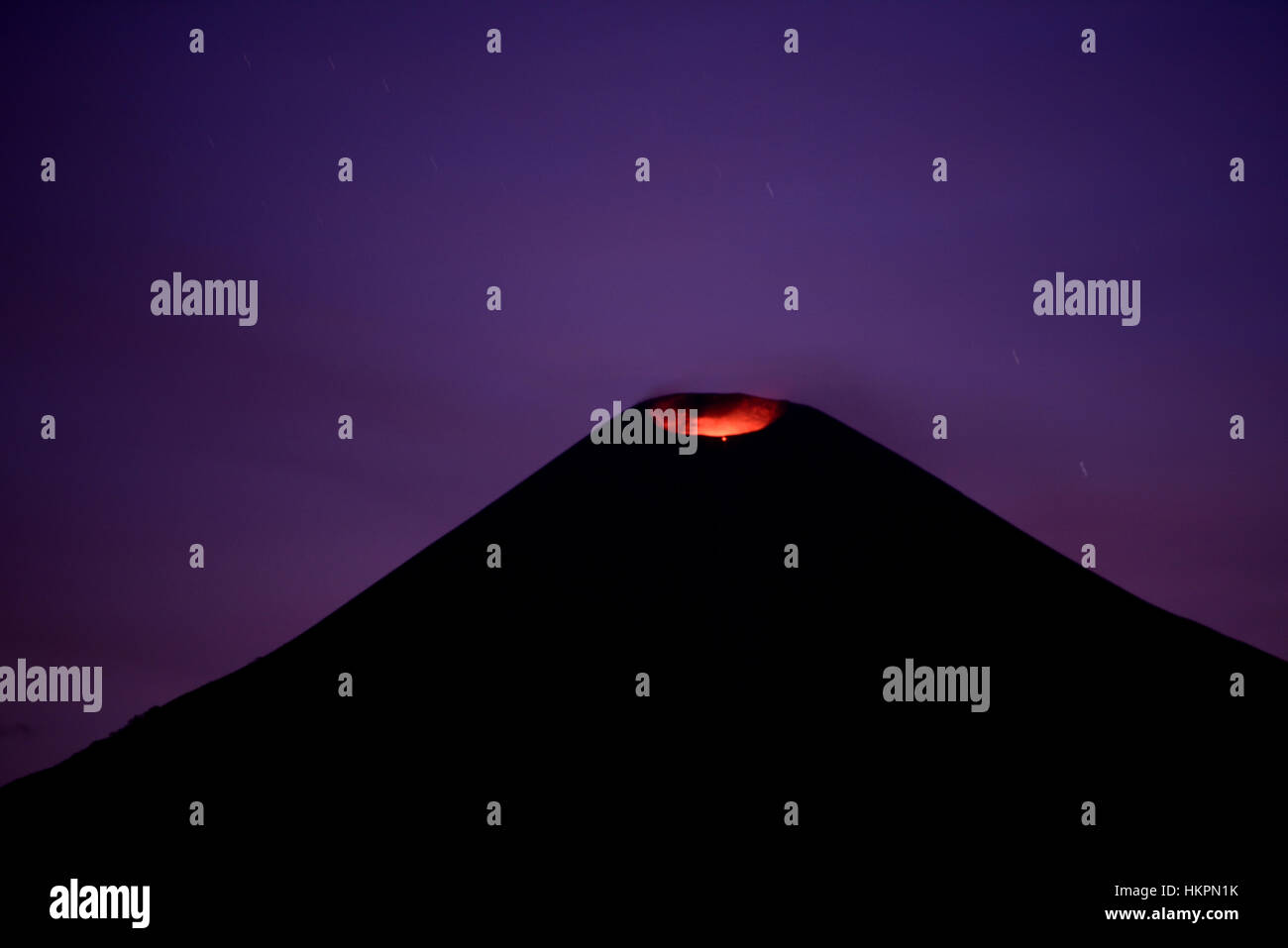 Volcano crater at night in violet colour background Stock Photo - Alamy