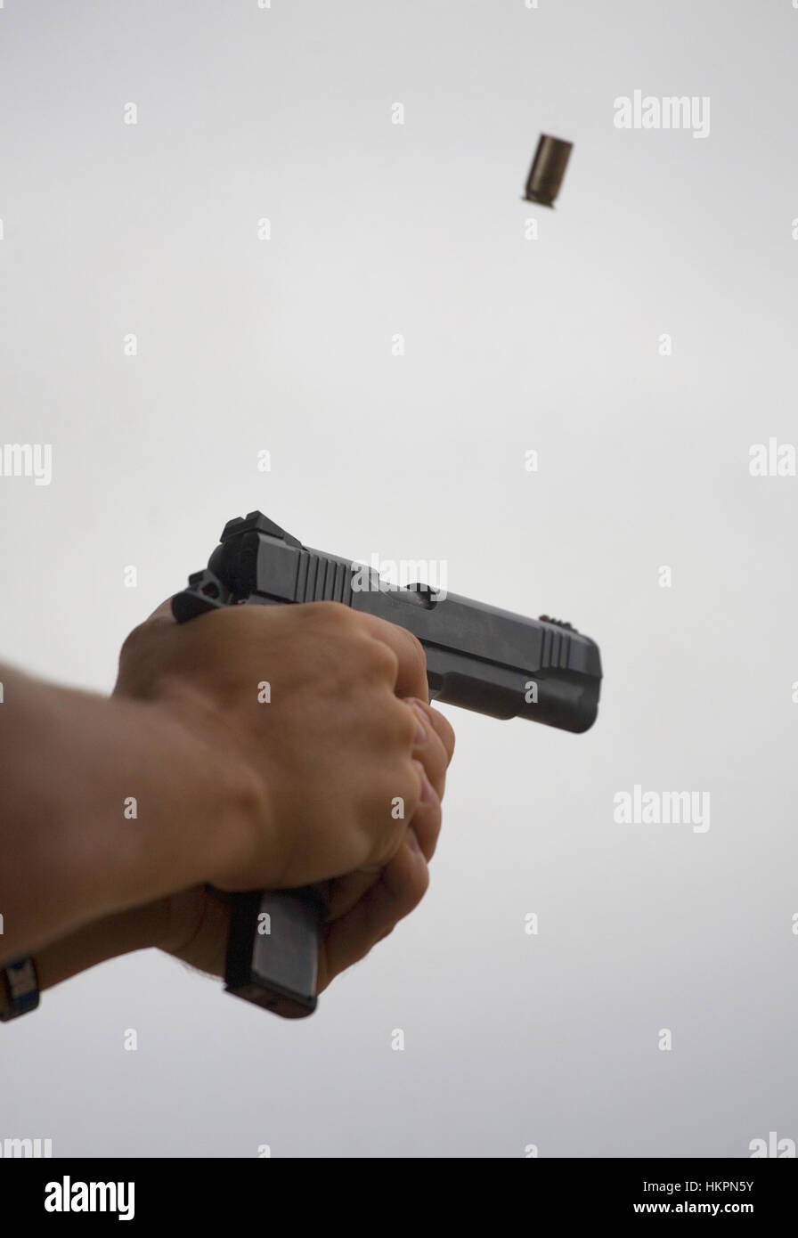 Empty shell casing flying high after being ejected from a handgun Stock ...