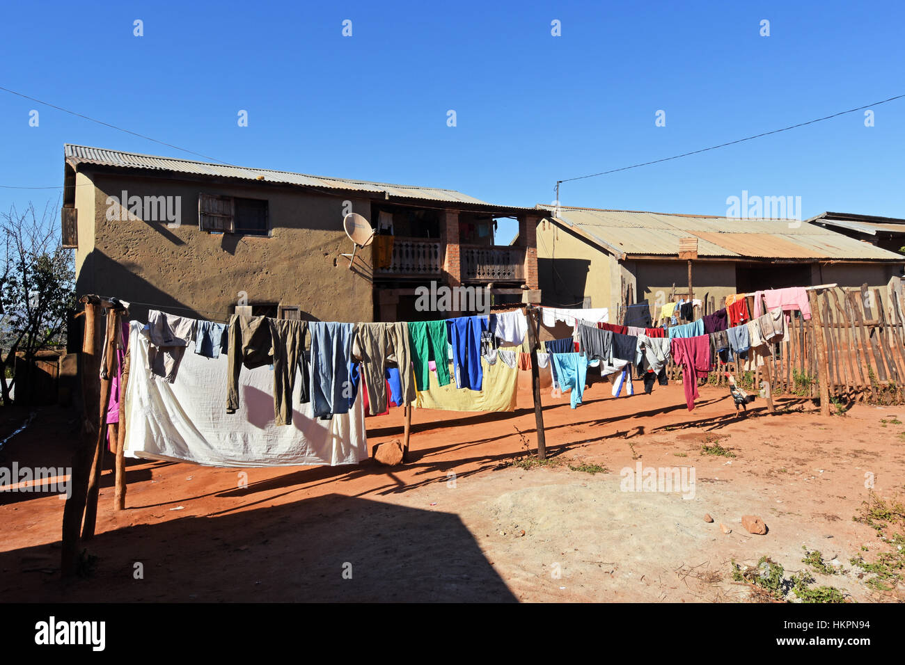 Washing drying in the sun on a washing line in the yard of of a house ...