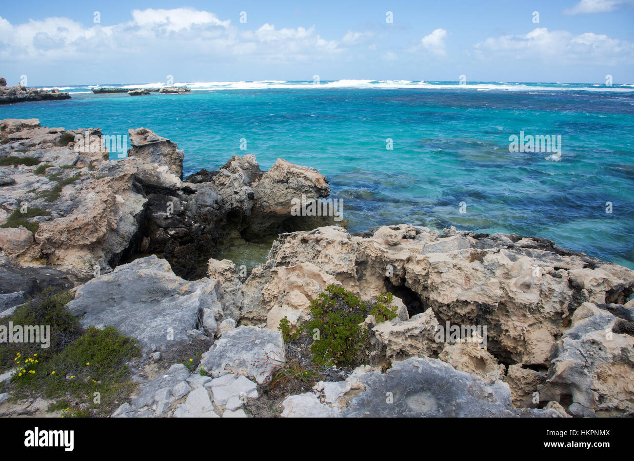 Rugged limestone on the coast of Rottnest Island with Indian Ocean reef ...