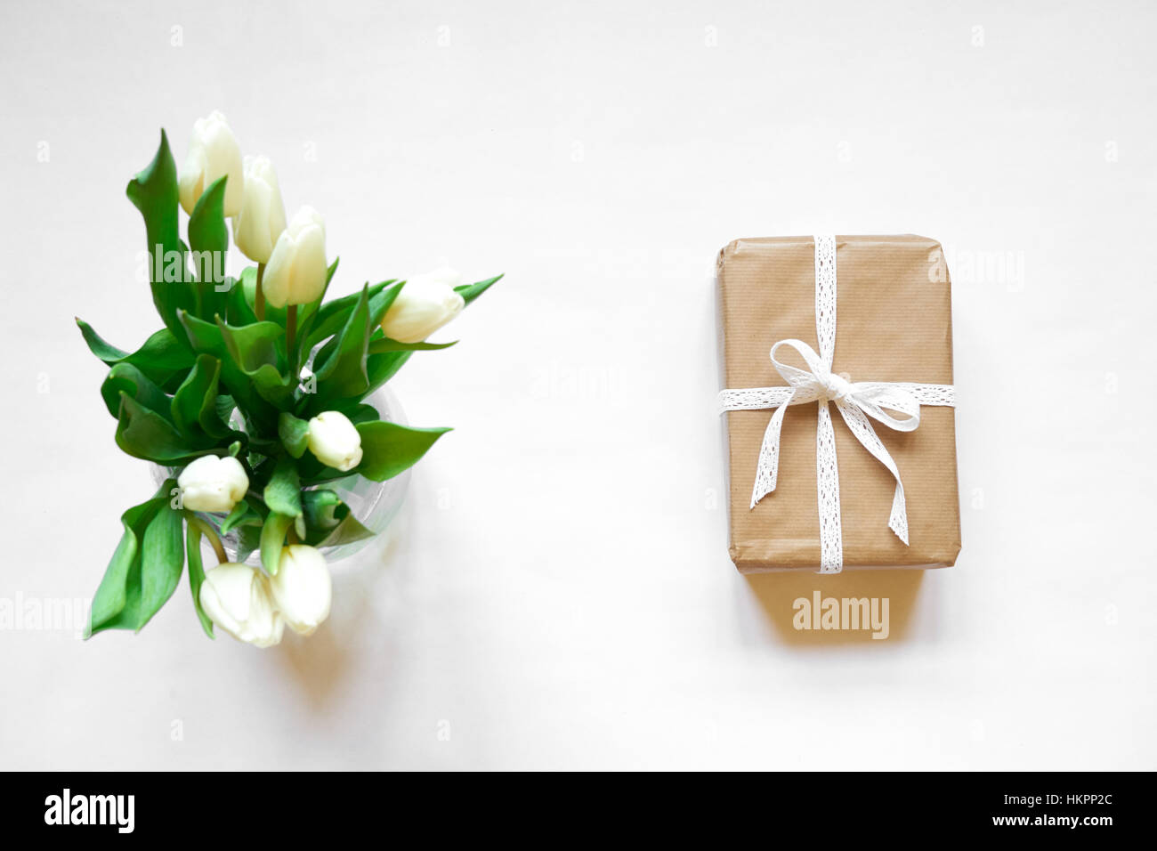 Top view of white tulips and box gift Stock Photo - Alamy