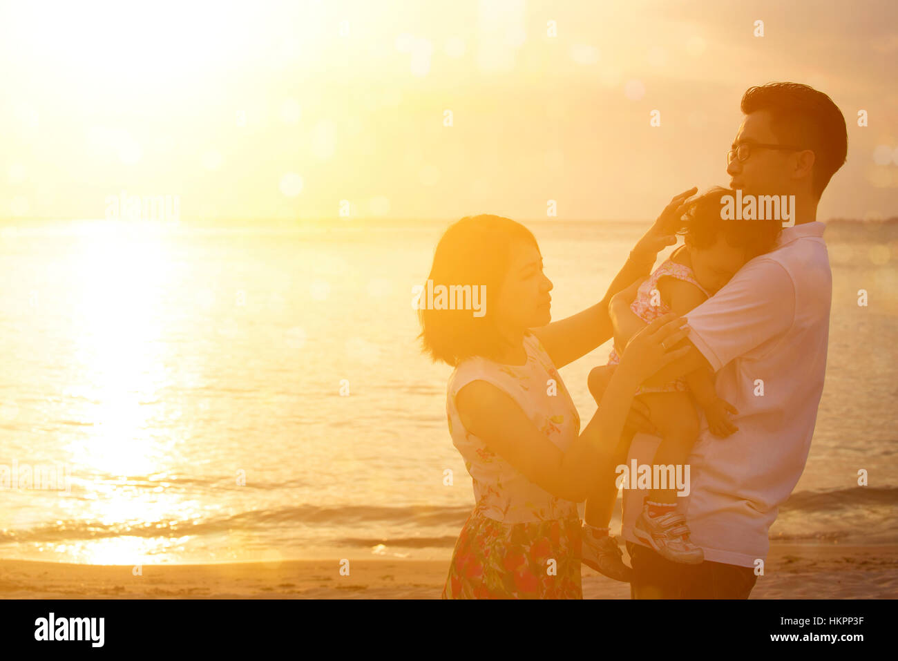 Silhouette of Asian family outdoor portrait, enjoying holiday together ...