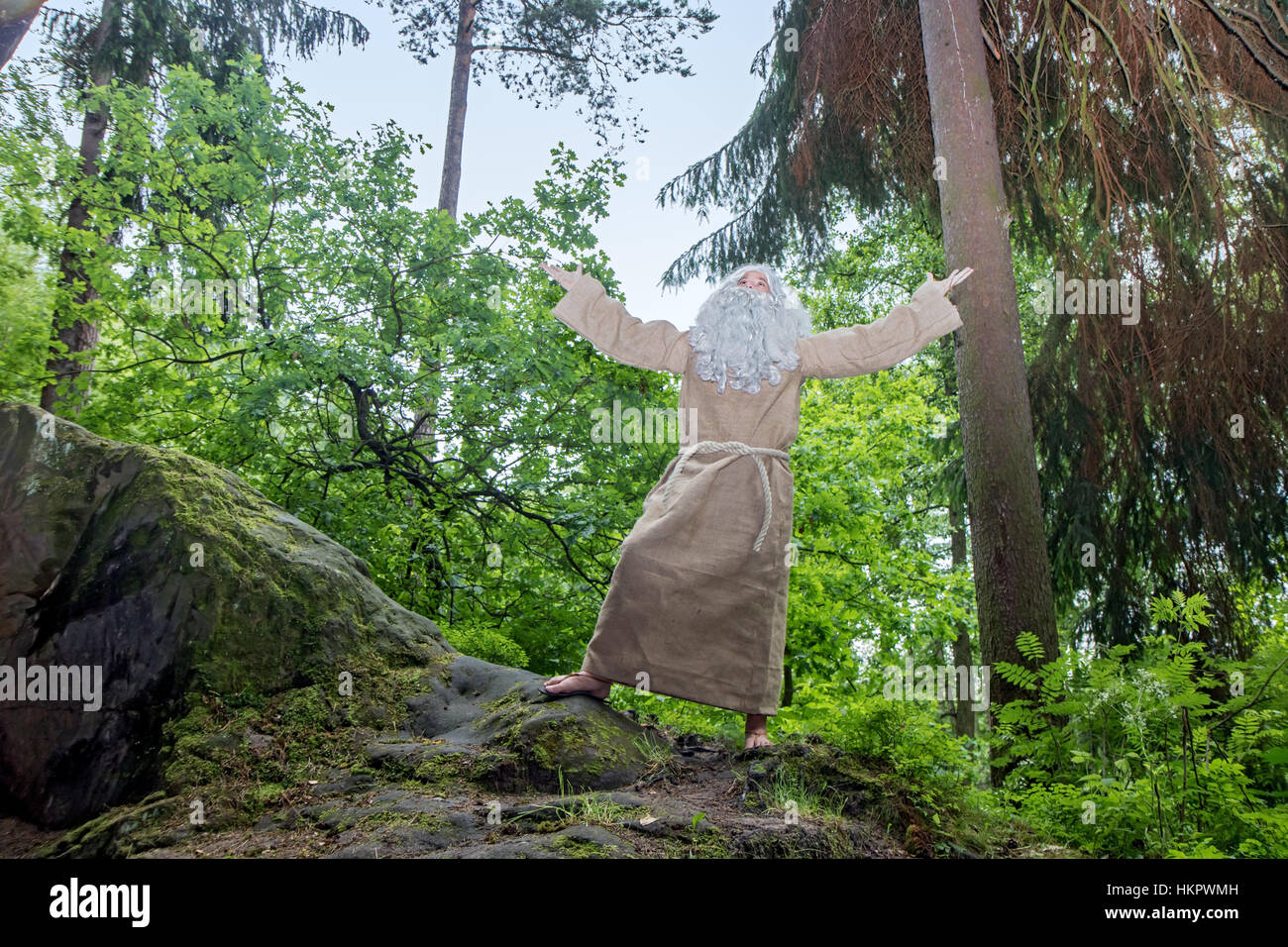 Bearded Man worshiping God in nature.The old hermit lifted up his hands ...