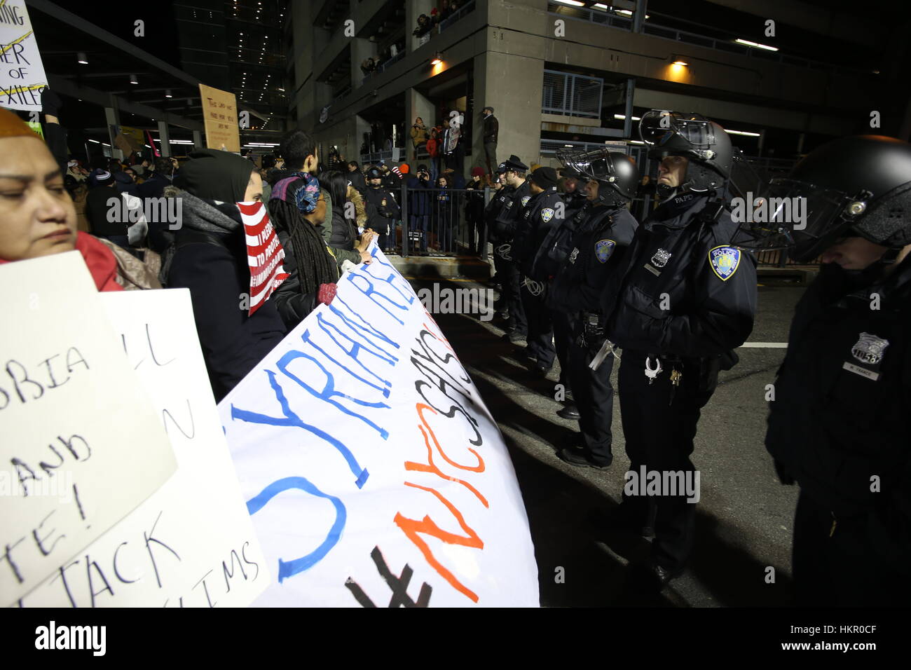 Protestors with banner face off Port Authority police. Thousands ...
