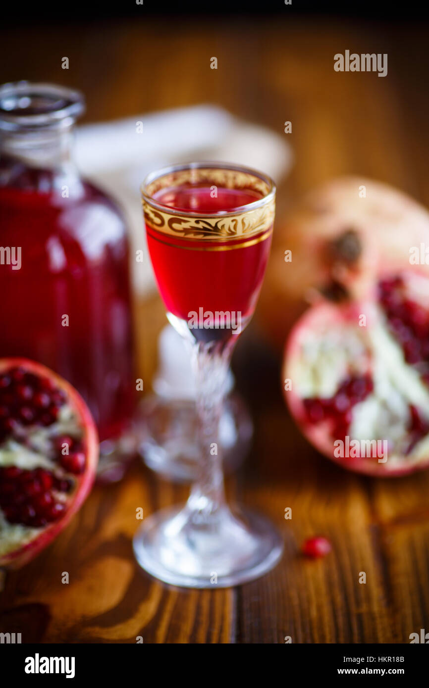 sweet pomegranate alcoholic cordial in the decanter with a glass Stock ...