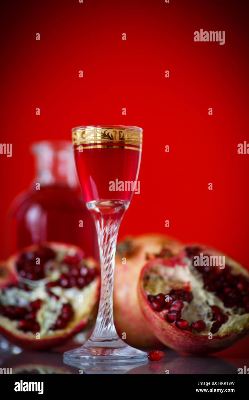 sweet pomegranate alcoholic cordial in the decanter with a glass Stock ...